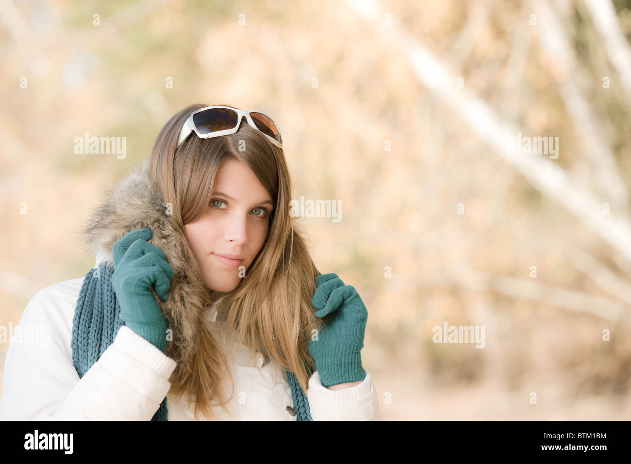 Winter fashion - woman with fur hood and gloves outside, desaturated ...