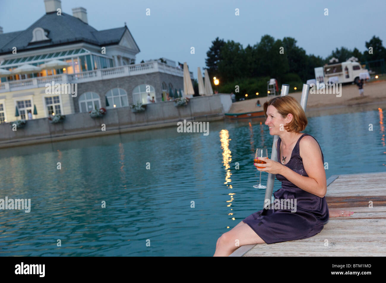 woman with Aperol Sprizz sitting on landing stage Stock Photo - Alamy