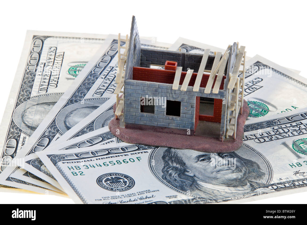 A shell construction house. Funding with dollar bills Stock Photo - Alamy
