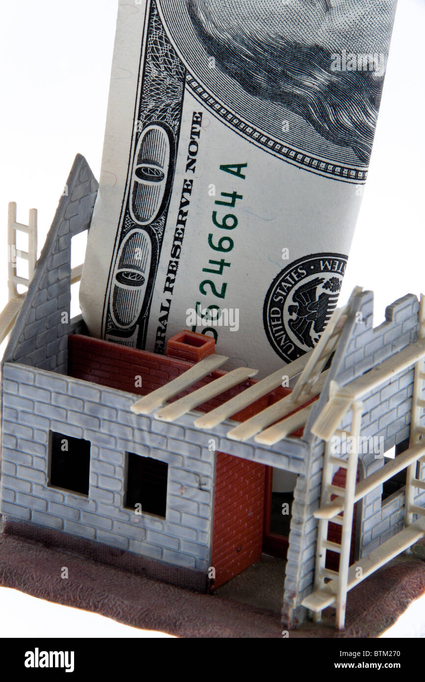 A shell construction house. Funding with dollar bills Stock Photo - Alamy
