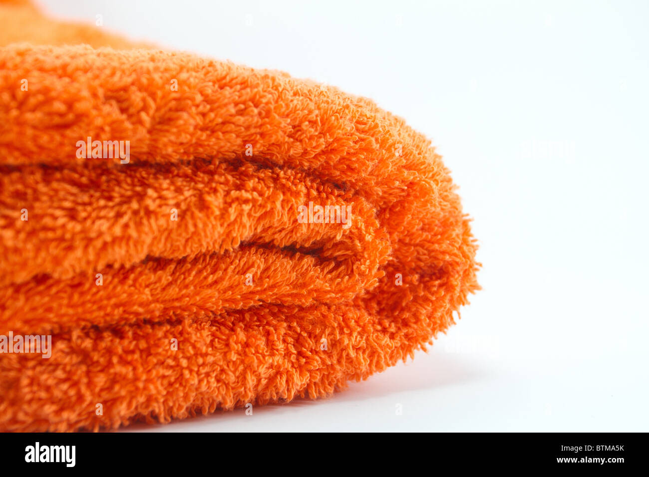 orange towel on white background Stock Photo - Alamy