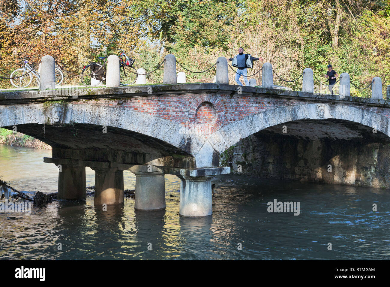 Man and woman jogging over a bridge in Parco di Monza Stock Photo - Alamy