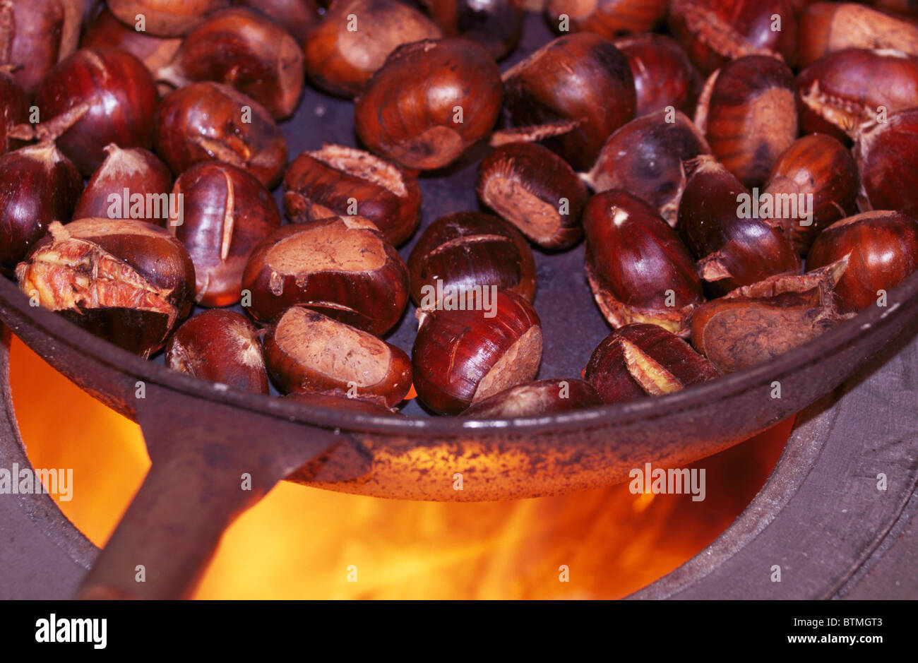 Roasting chestnuts on a brazier alba hi-res stock photography and ...
