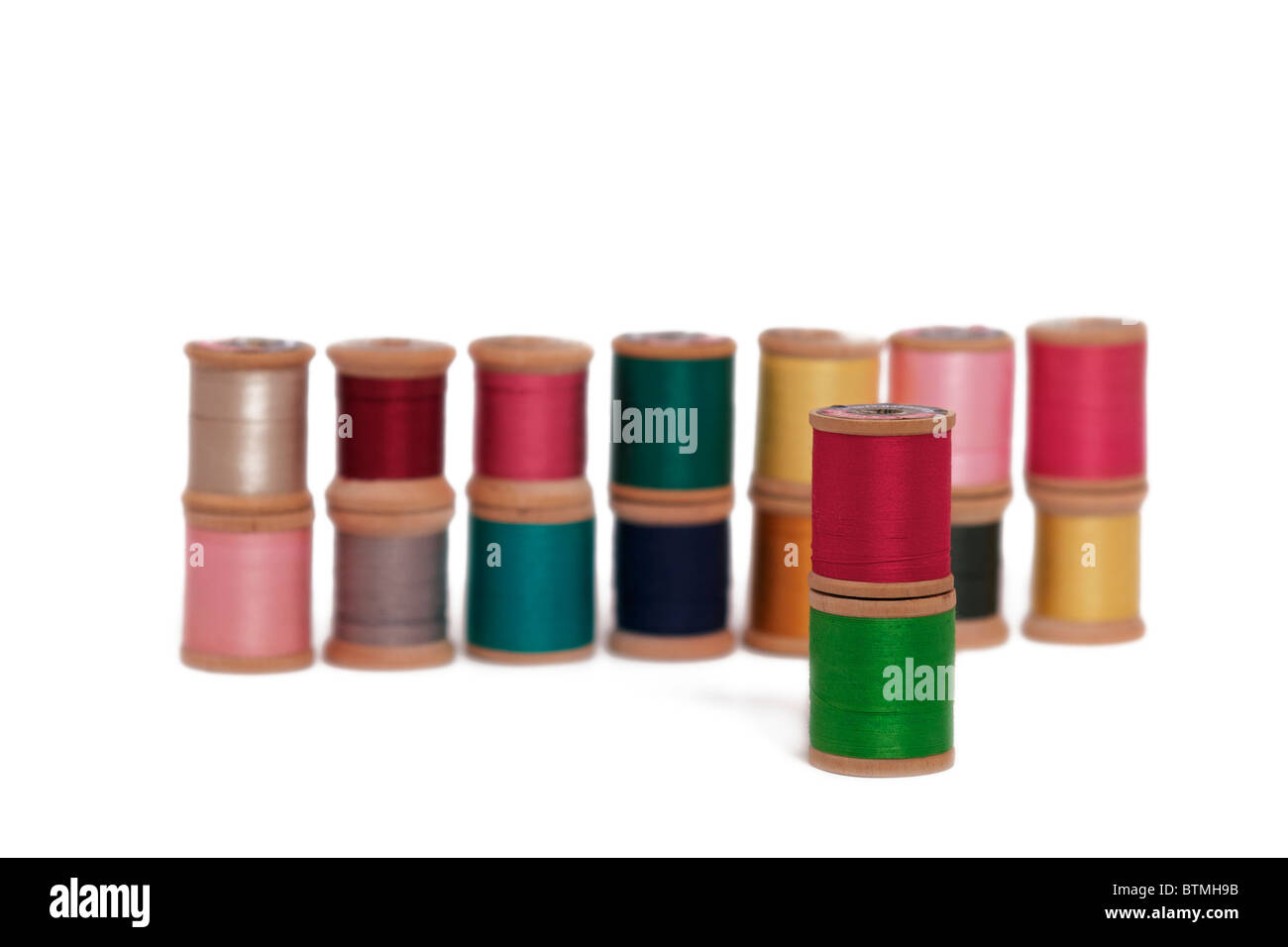 Stacked Spools of Colorful Thread on a White Background Stock Photo - Alamy