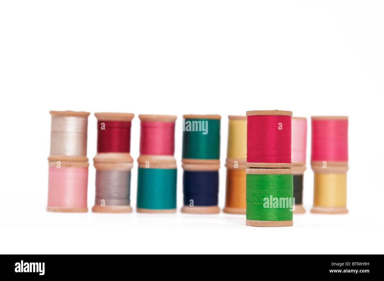 Stacked Spools of Colorful Thread on a White Background Stock Photo - Alamy