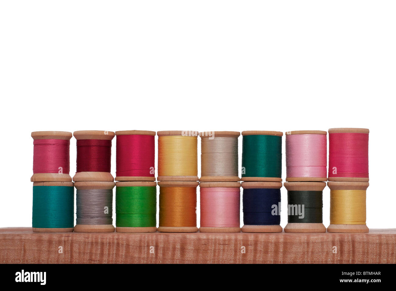 Stacked Spools of Colorful Thread on a White Background Stock Photo - Alamy