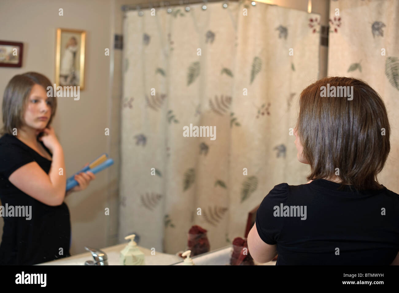 A teenage girl getting ready in the bathroom Stock Photo - Alamy