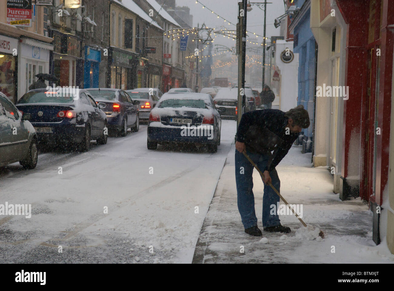 Man clearing path in snow hi-res stock photography and images - Alamy