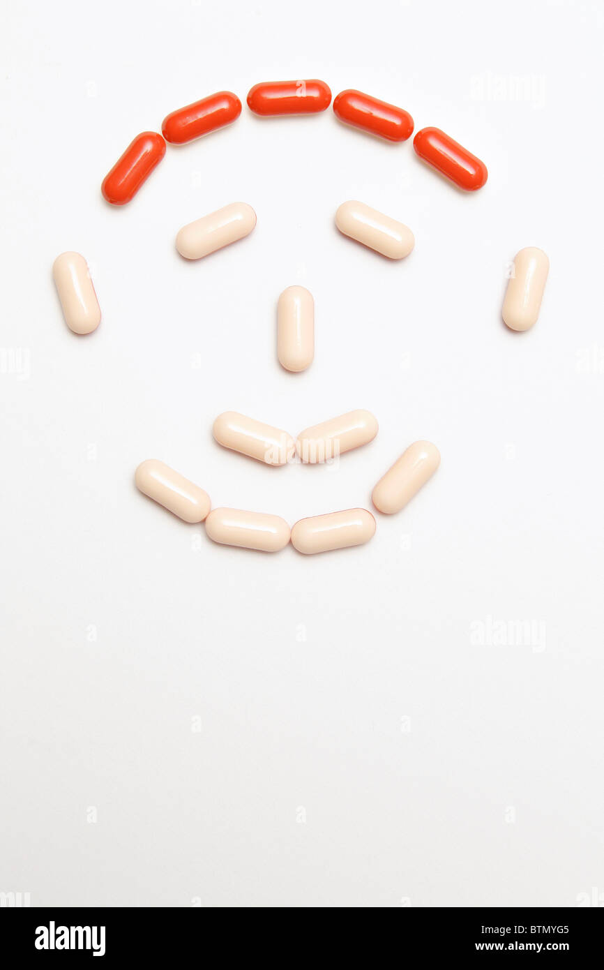 medication and pills face on gray background Stock Photo - Alamy