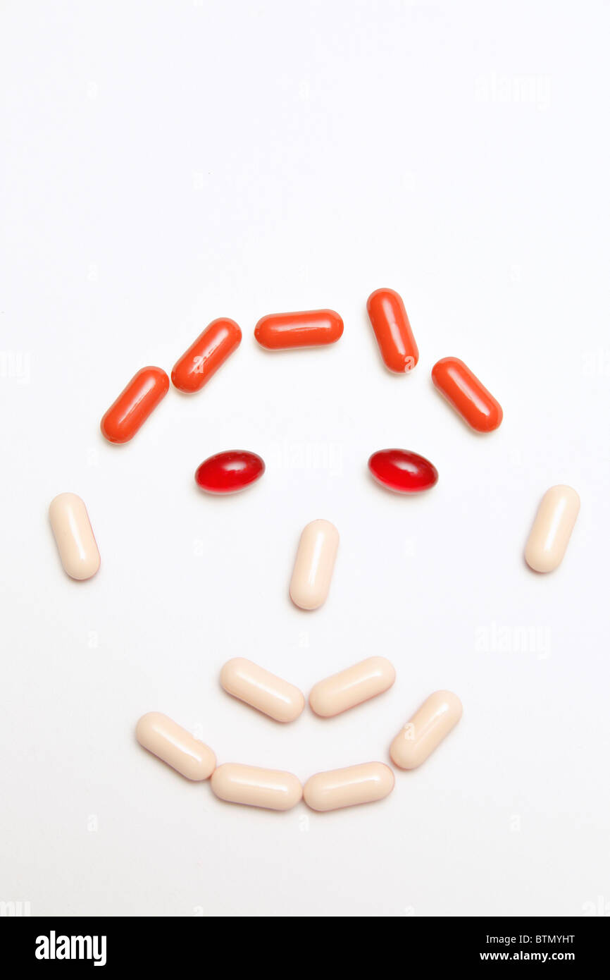 medication and pills face on gray background Stock Photo - Alamy