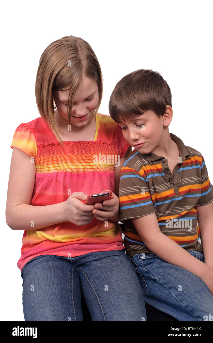 Two young kids texting messages on a smart phone Stock Photo - Alamy