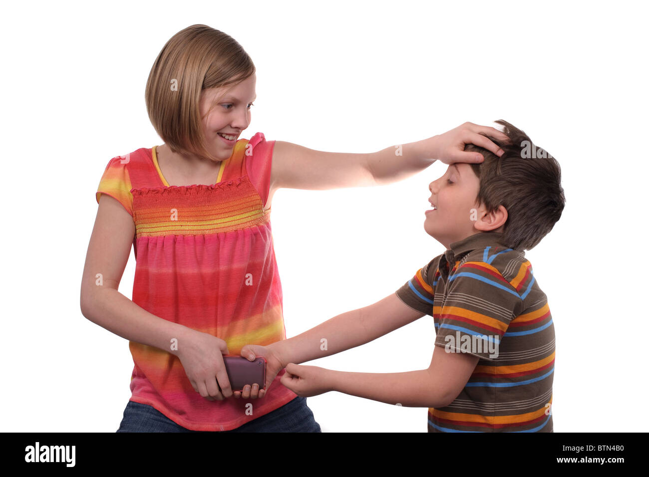 Two young kids fighting over a cell phone Stock Photo - Alamy