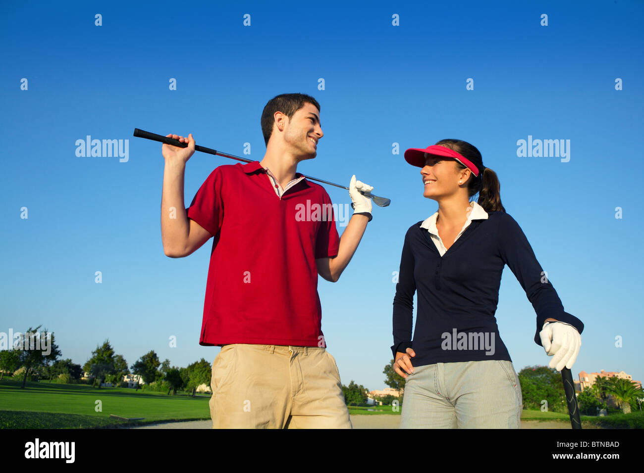Golf course young happy players couple talking posing on bunker Stock ...