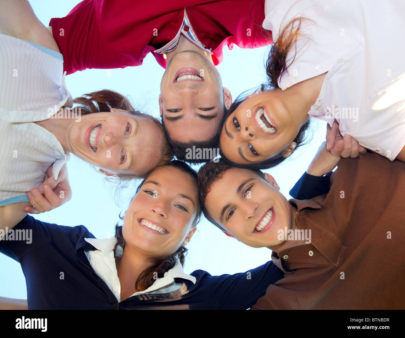 friends happy group in circle heads smiling together from below view ...