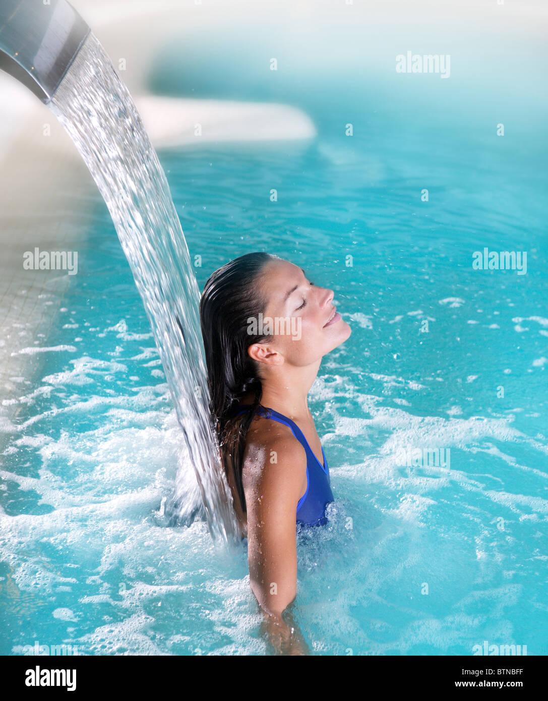 spa hydrotherapy woman waterfall jet turquoise swimming pool water ...