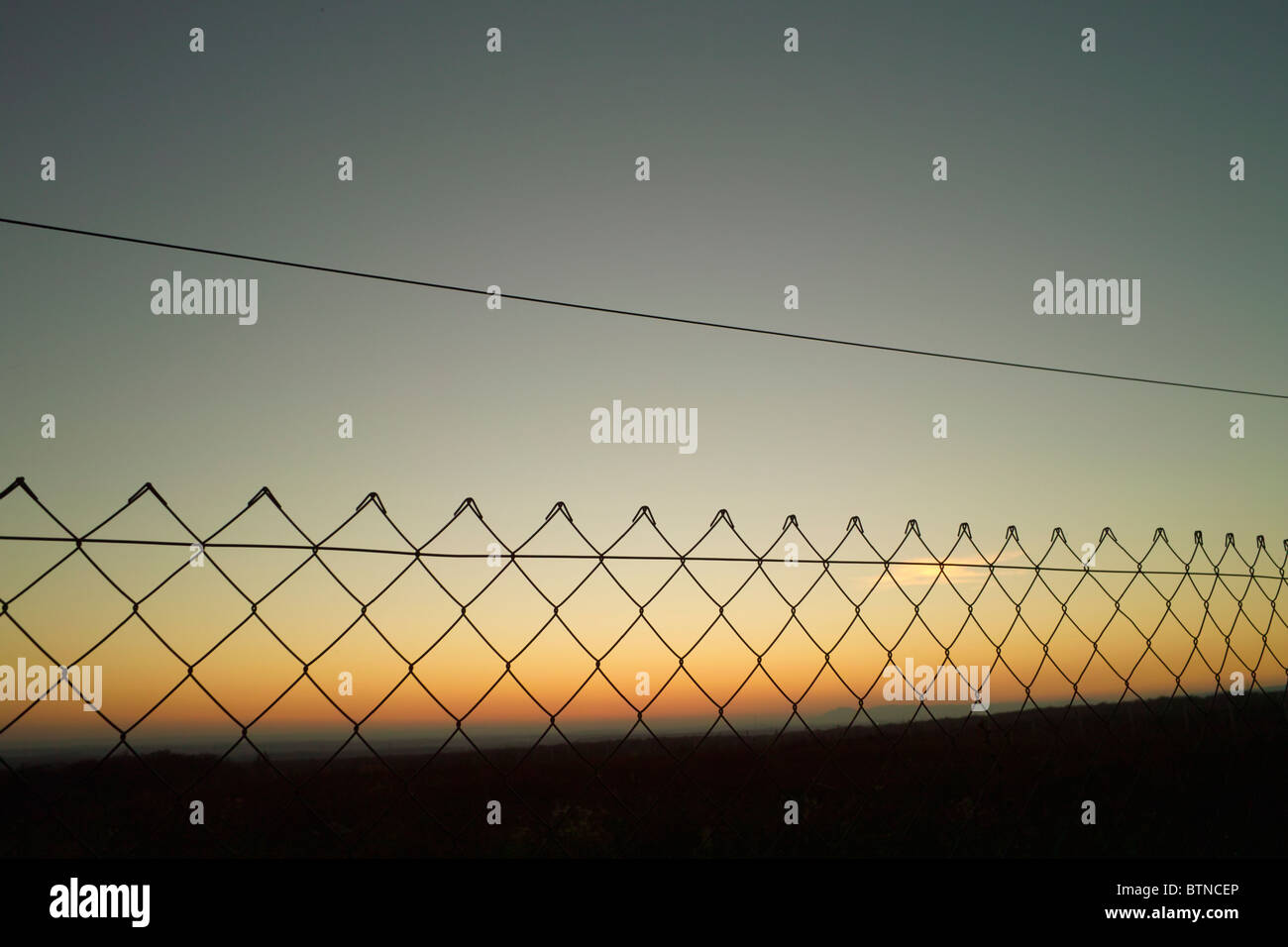 Sunset through fence hi-res stock photography and images - Alamy