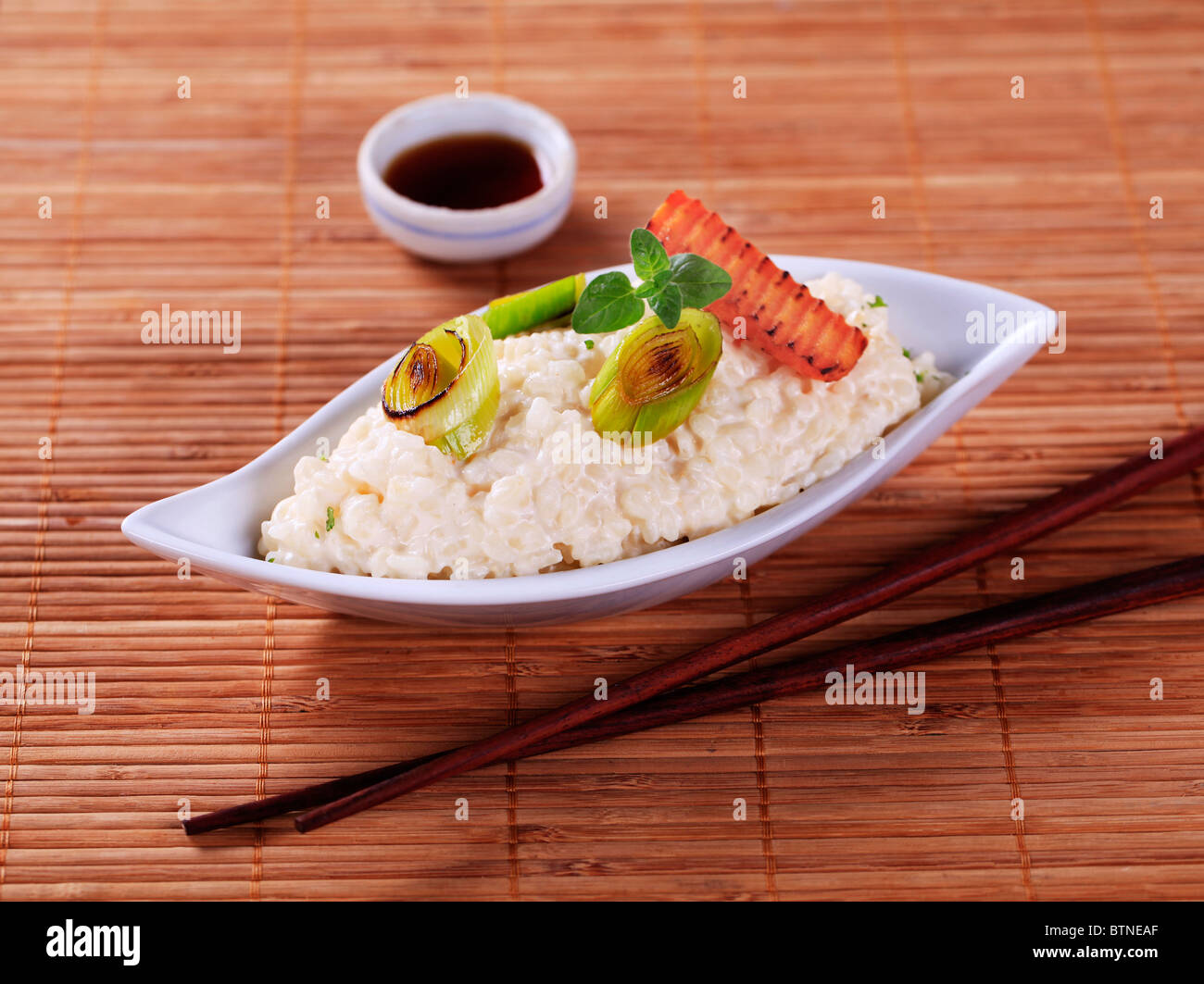 Bowl of rice pudding and soy sauce Stock Photo - Alamy
