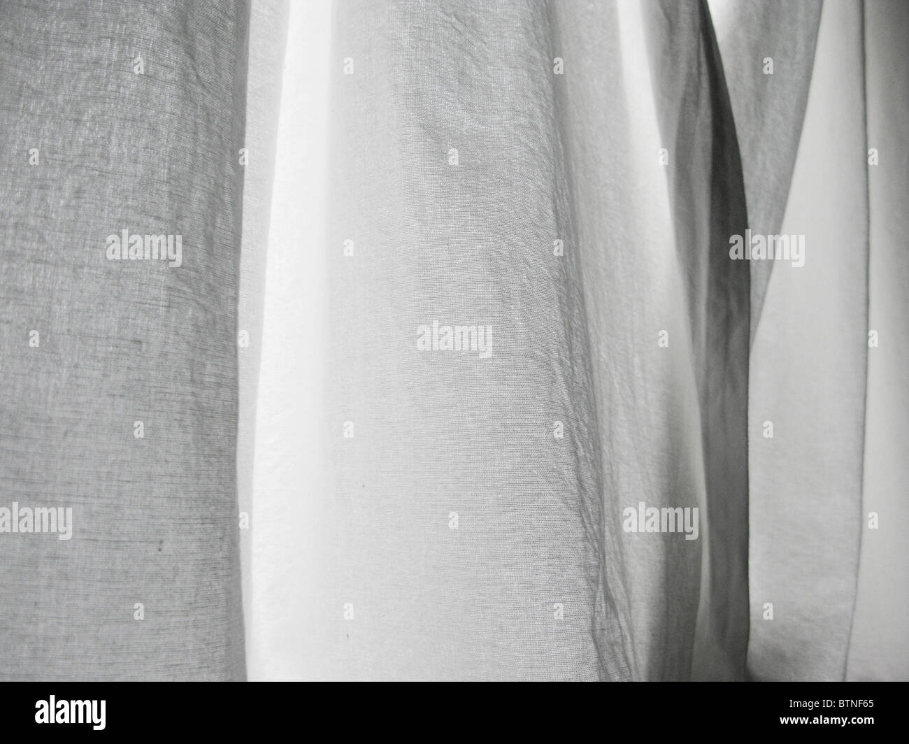 White cotton curtains with daylight filtering through on a Winter day ...