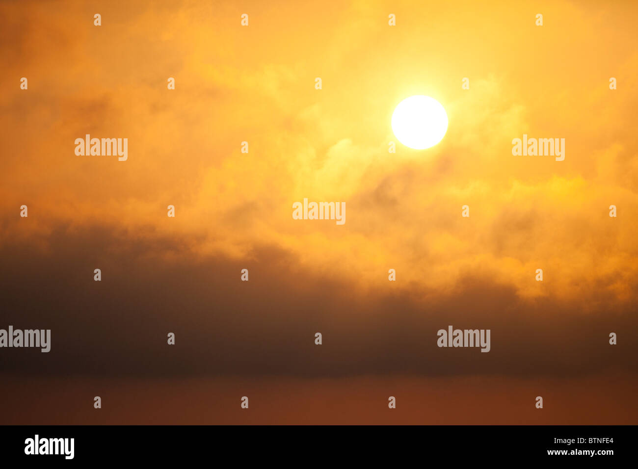 Warm sunset colors and dramatic clouds background Stock Photo - Alamy