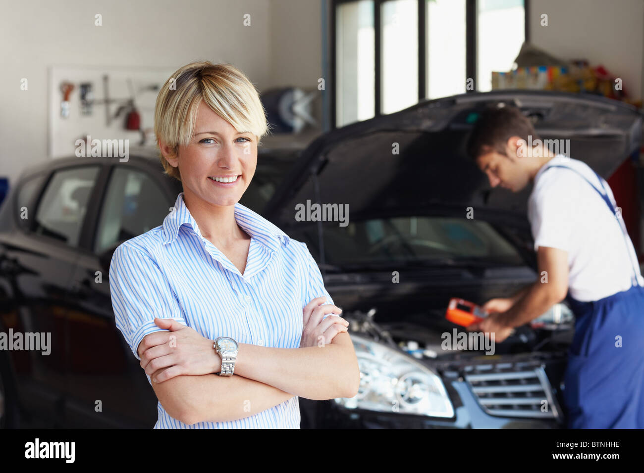 portrait of woman in auto repair shop Stock Photo - Alamy