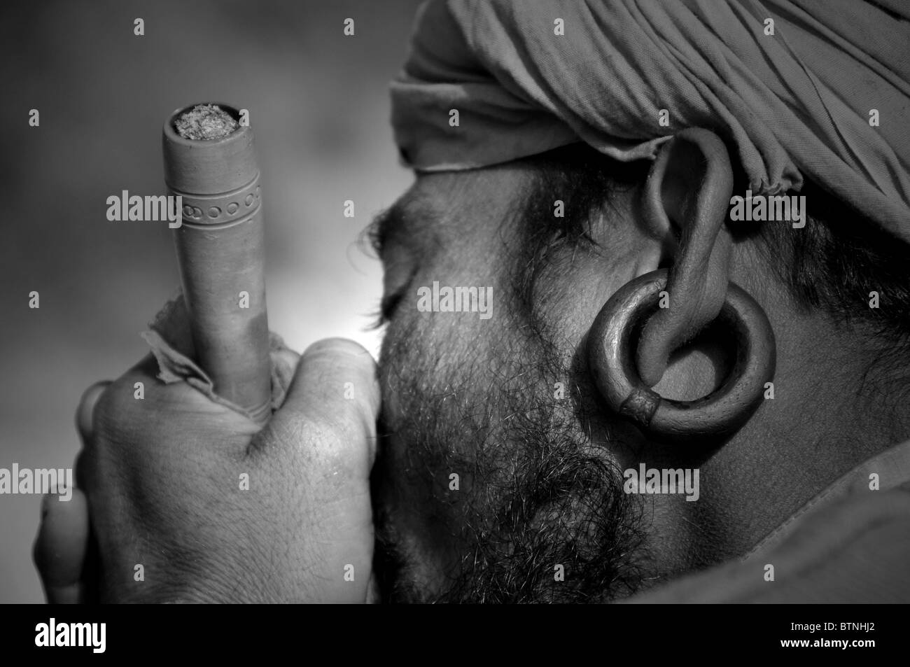 Sadhu smoking the chillum Stock Photo - Alamy