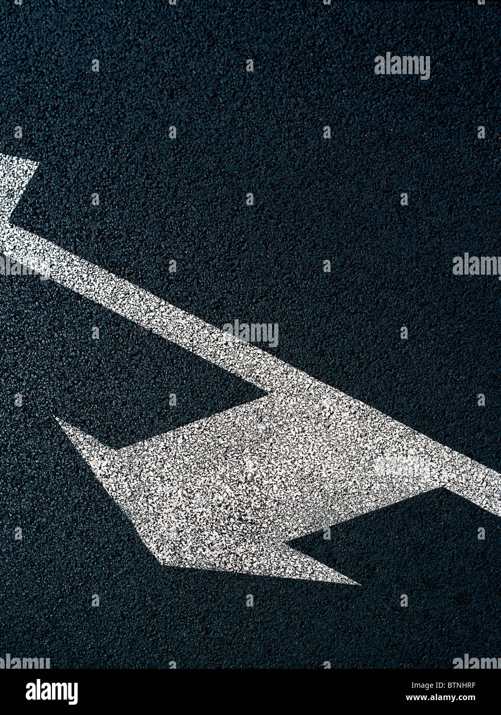 white painted street signage on asphalt Stock Photo - Alamy