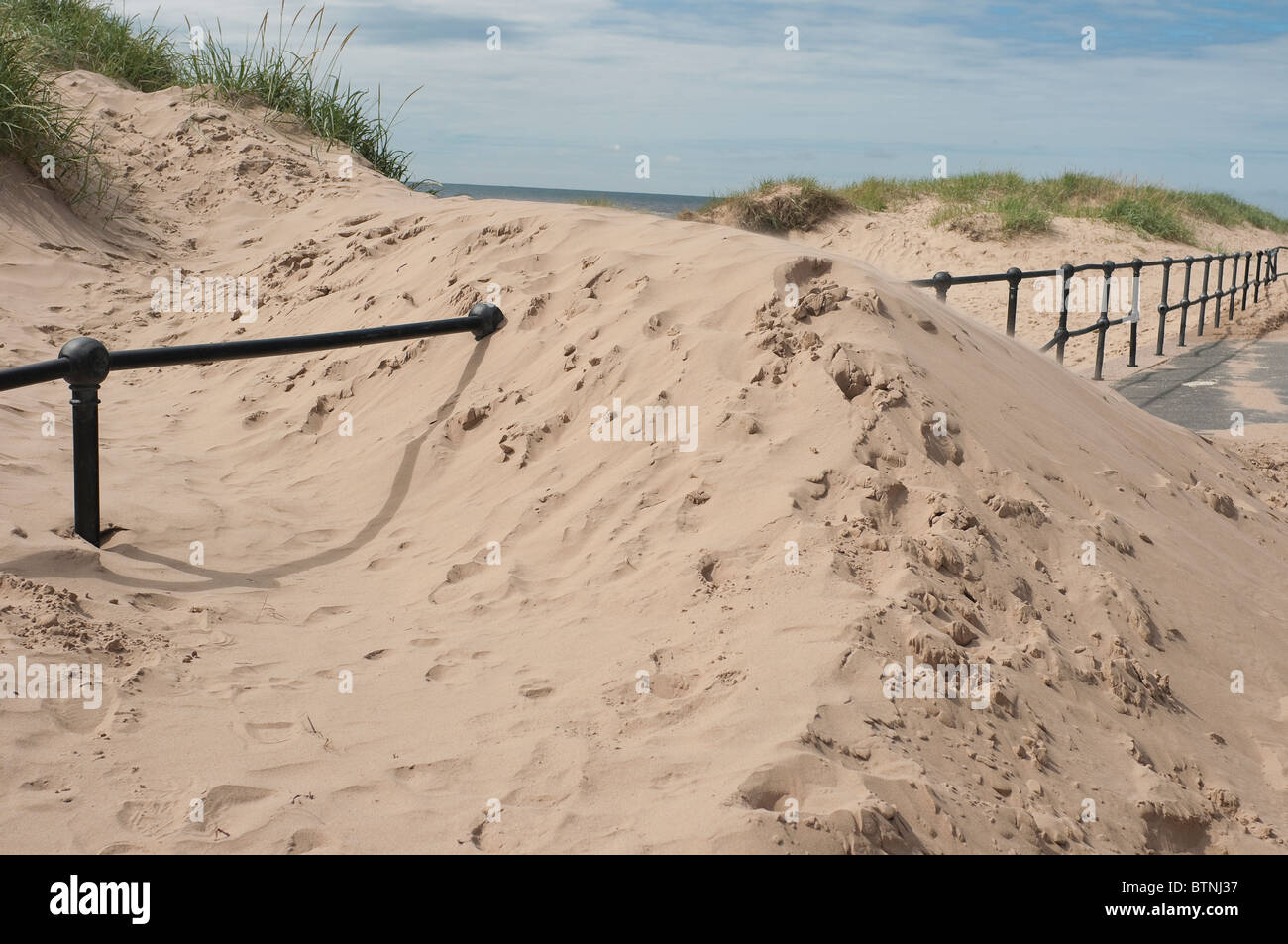 Sand dune encroachment on a path, covering hand rails, Crosby Beach ...