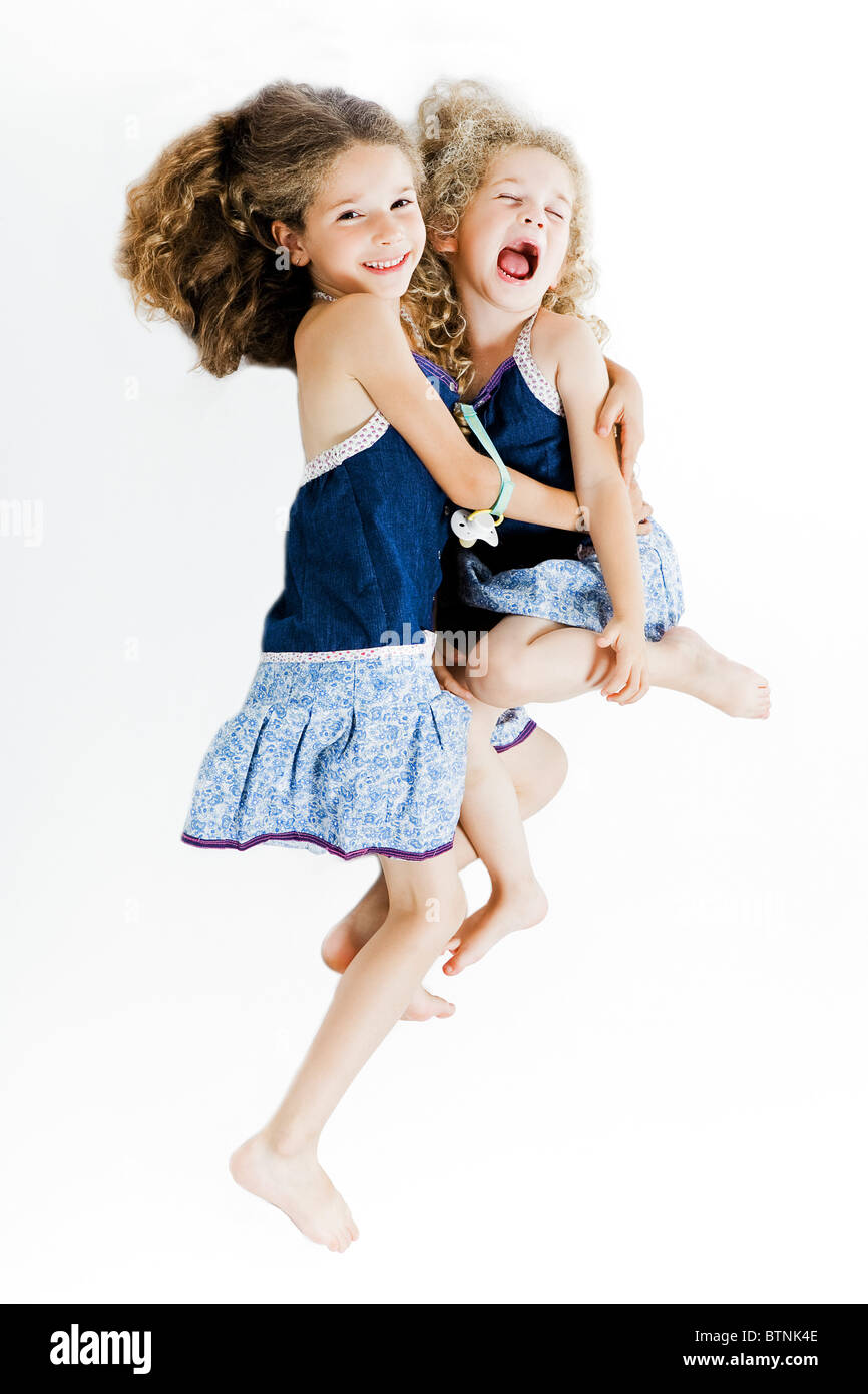 caucasian little girl cheer up hug sister isolated studio on white ...