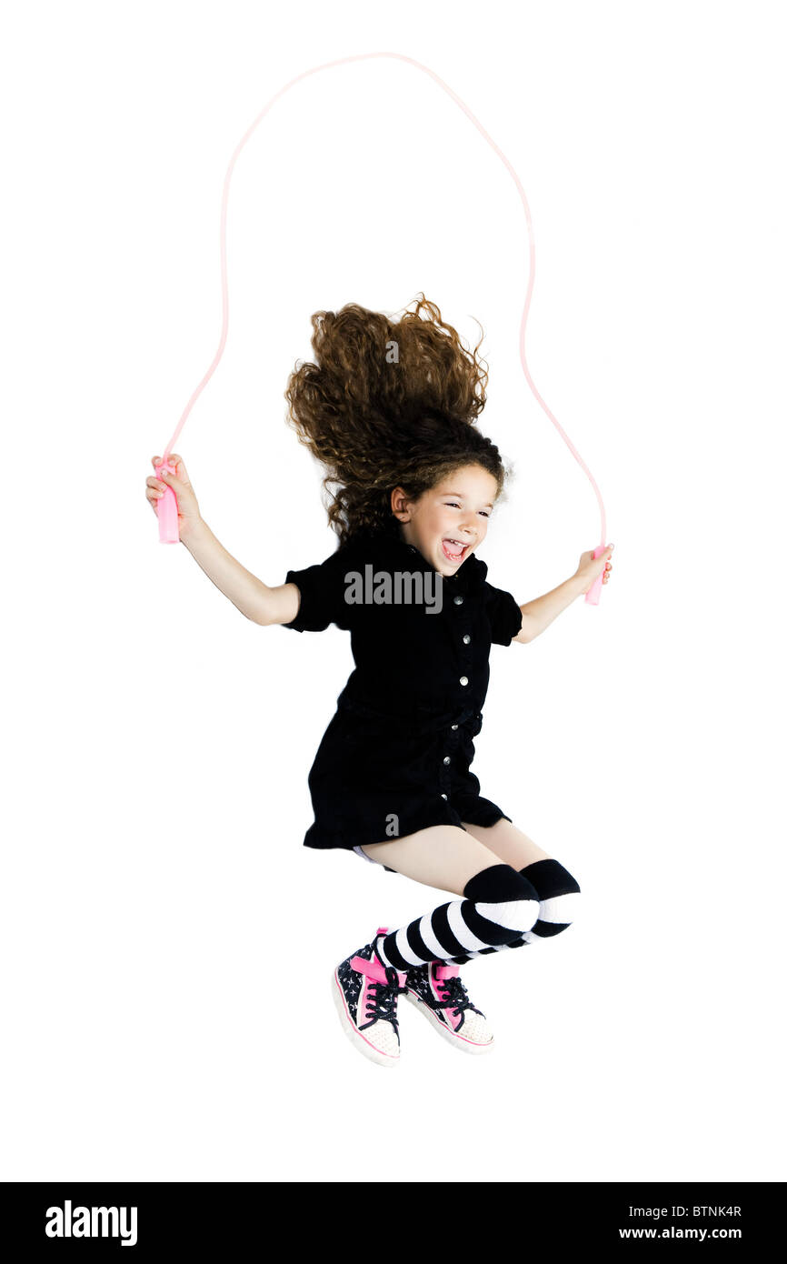 caucasian little girl jumping skipping rope isolated studio on white ...