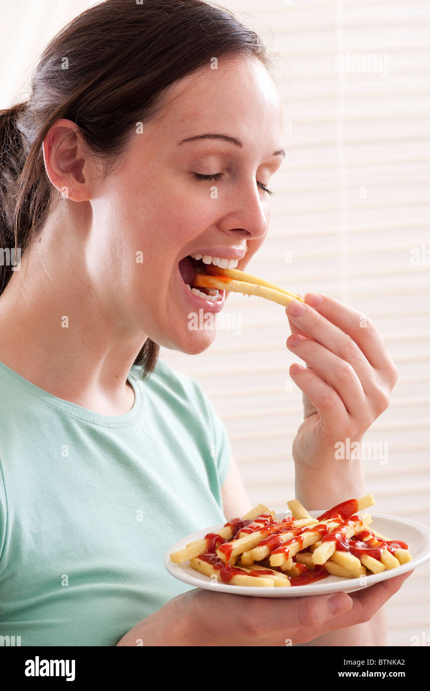 teeen eating french fries Stock Photo - Alamy