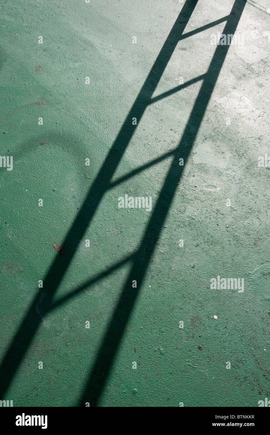 Shadow of a ship's ladder on a green deck Stock Photo - Alamy