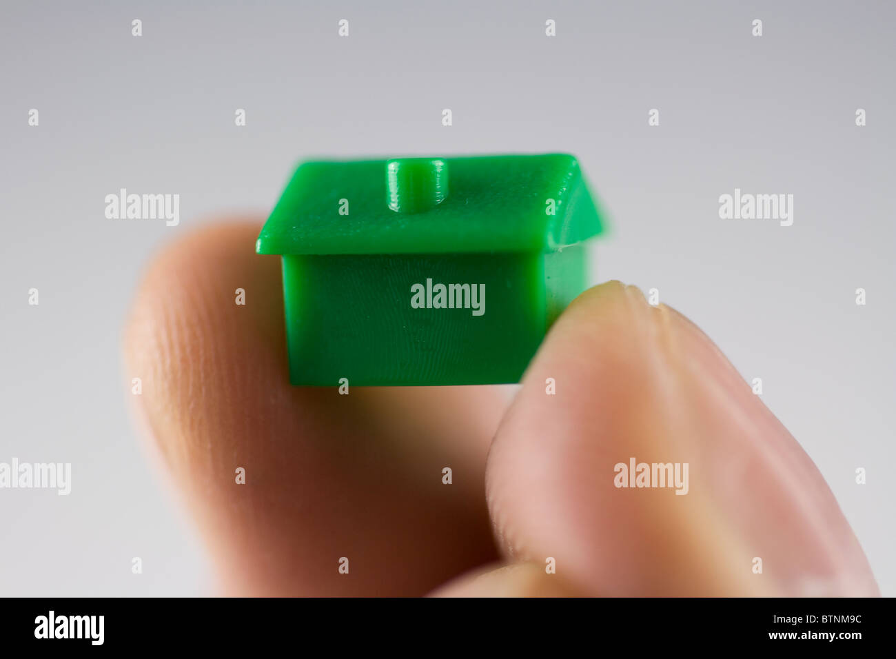 Holding a Monopoly house Stock Photo - Alamy