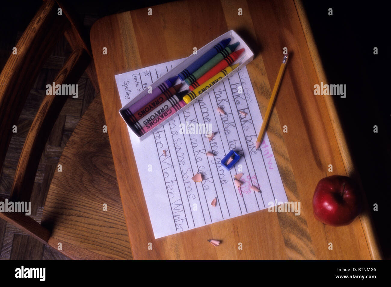Writing lesson in kindergarten with written work on desk with pencils ...