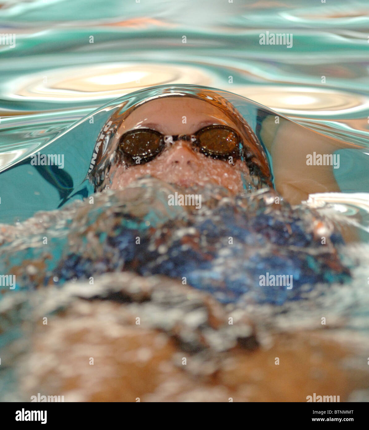 Young female swimmer swimming the backstroke Stock Photo - Alamy