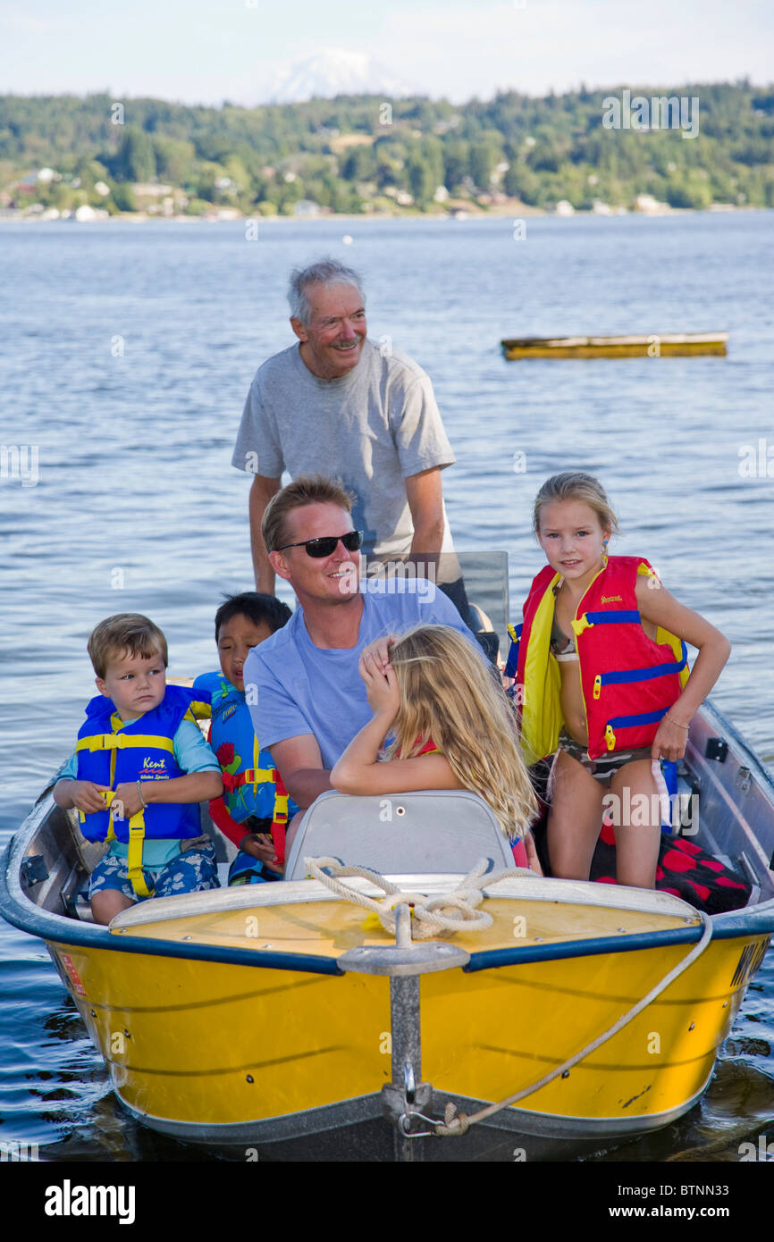 Men and young children on motorboat ride Stock Photo - Alamy