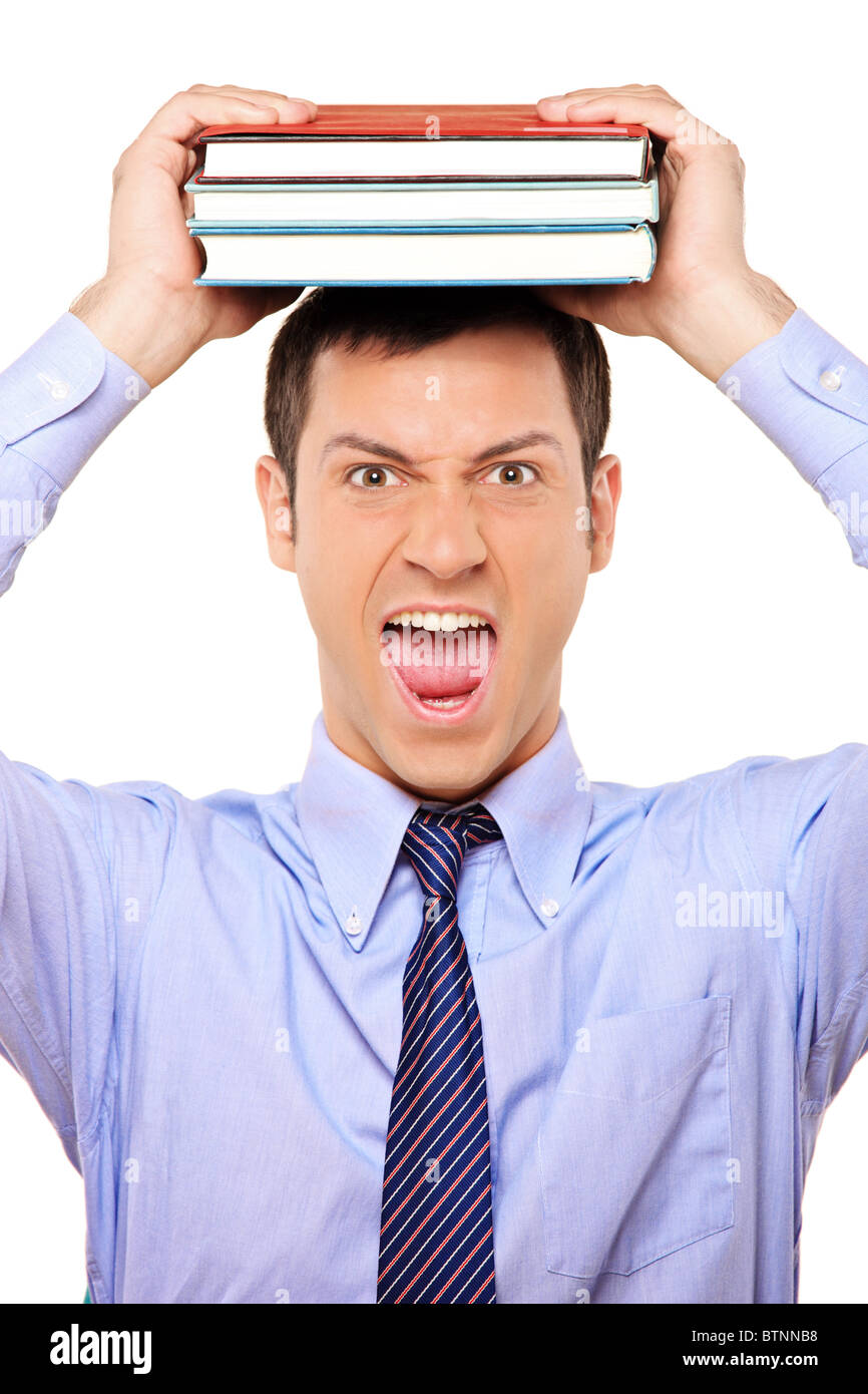 A portrait of a stressed young student holding book over his head Stock ...