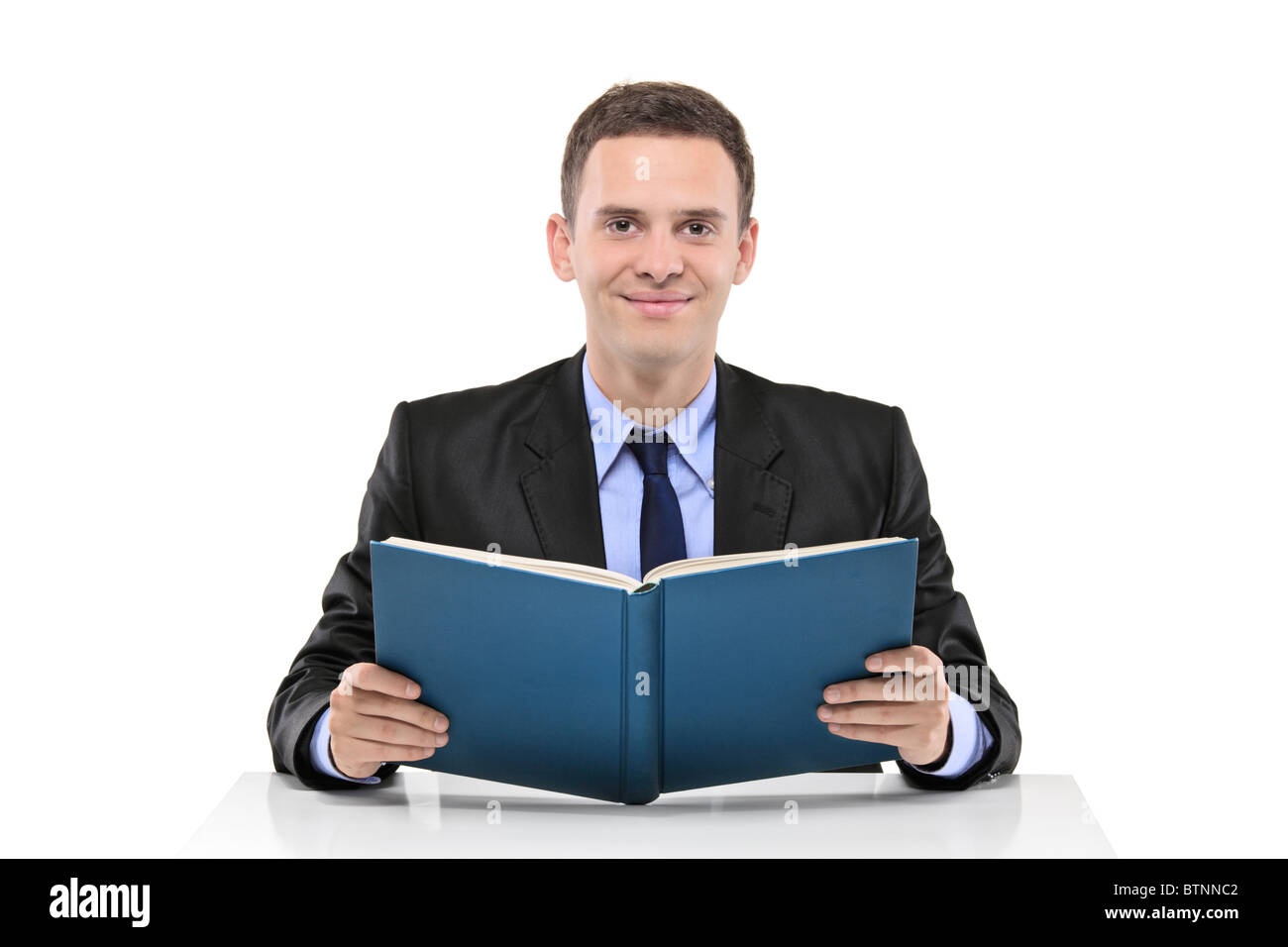 A young businessman reading a book Stock Photo - Alamy