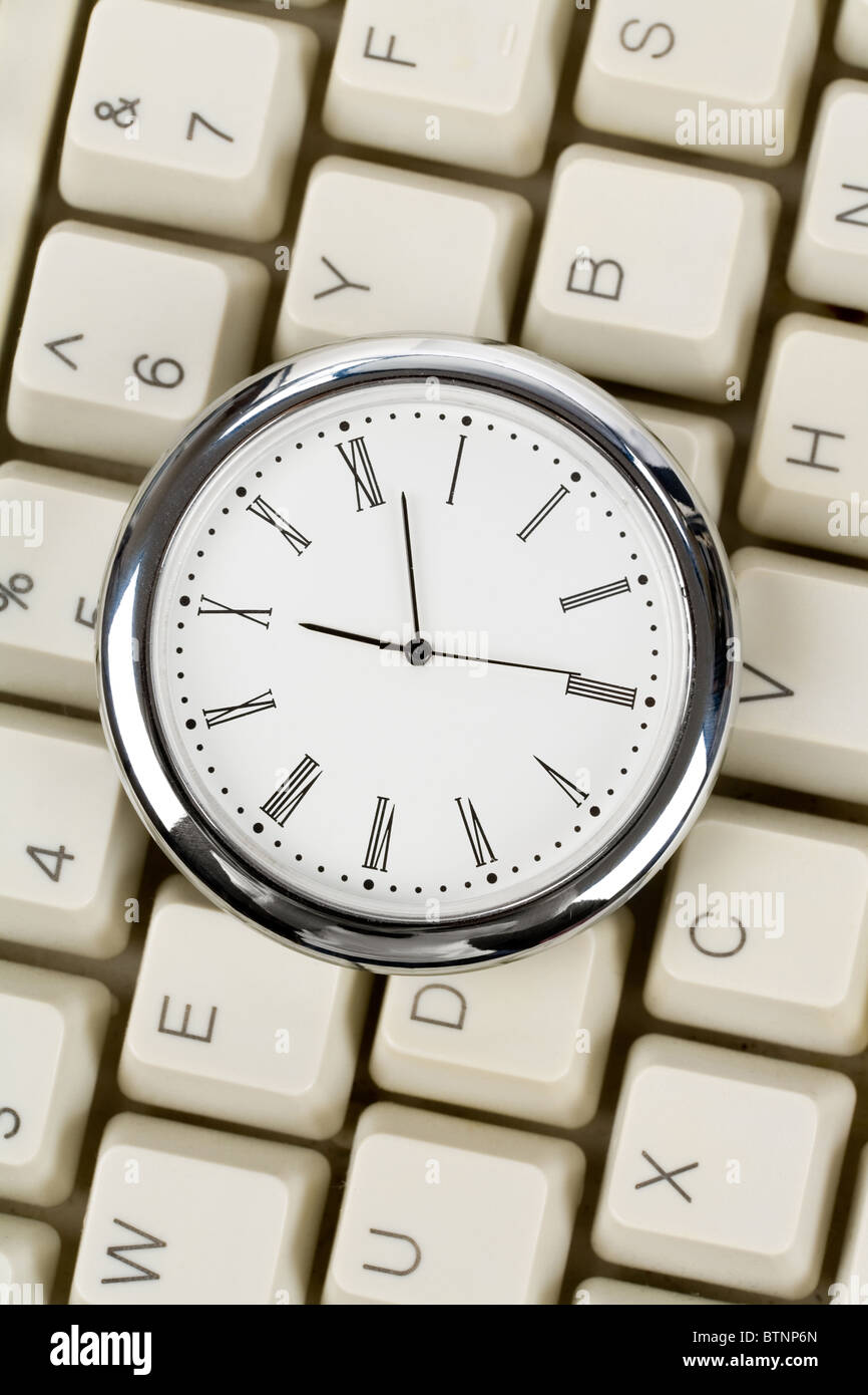 Clock and computer Keyboard close up Stock Photo - Alamy
