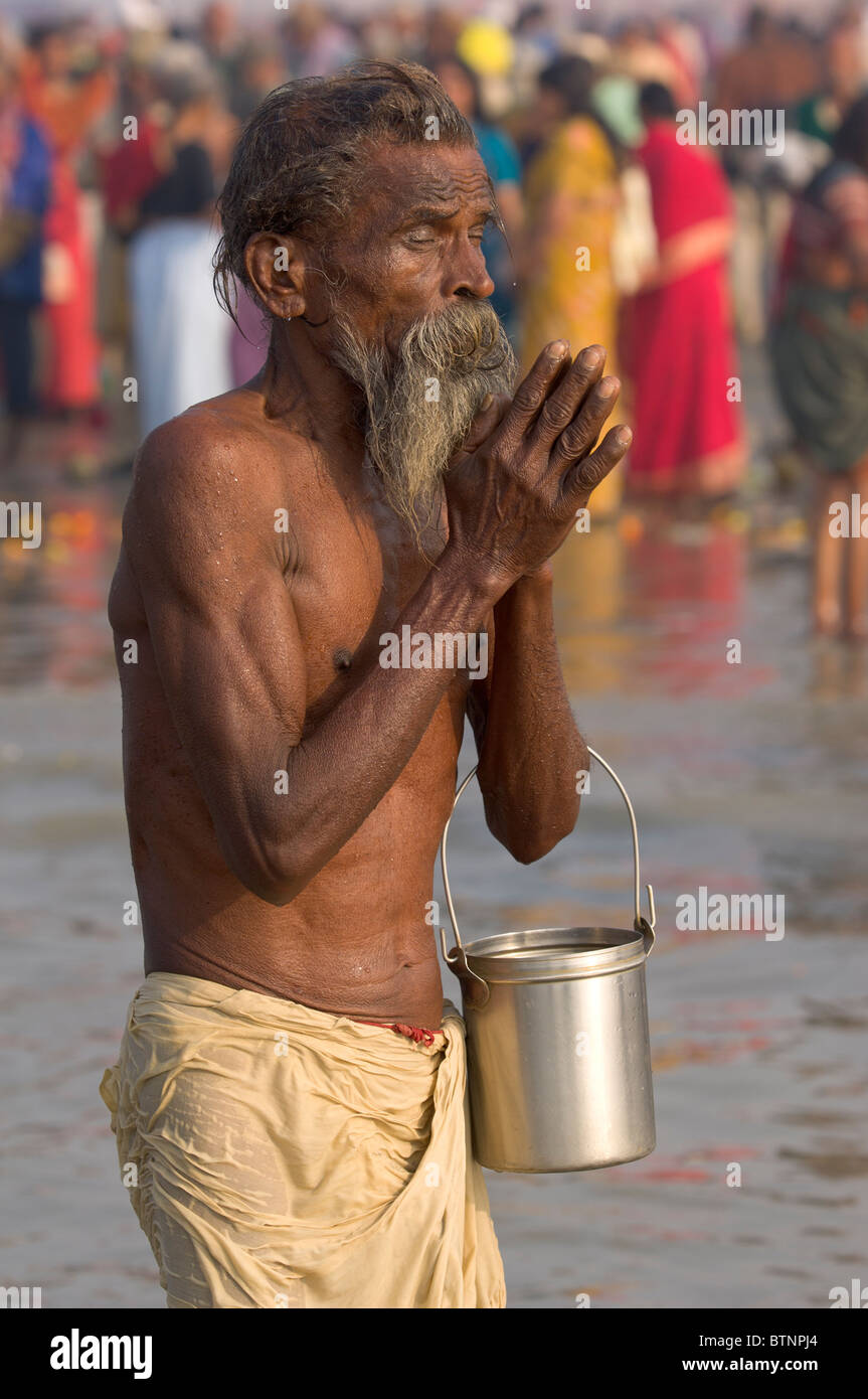 Male pilgrim with a long beard and moustache holding a kalasa ...