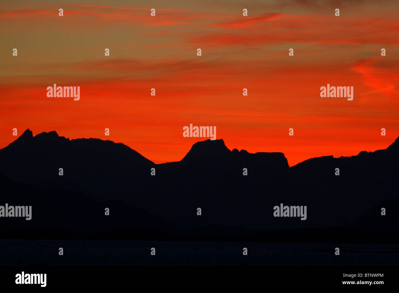 red sky over sharp mountain peak Stock Photo - Alamy