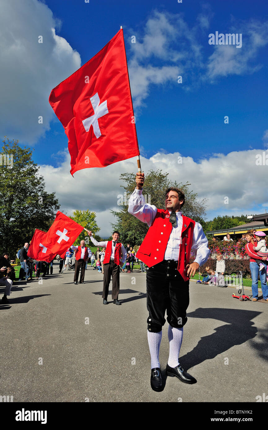 Three Swiss flag throwers performing at a festival of folklore Stock ...