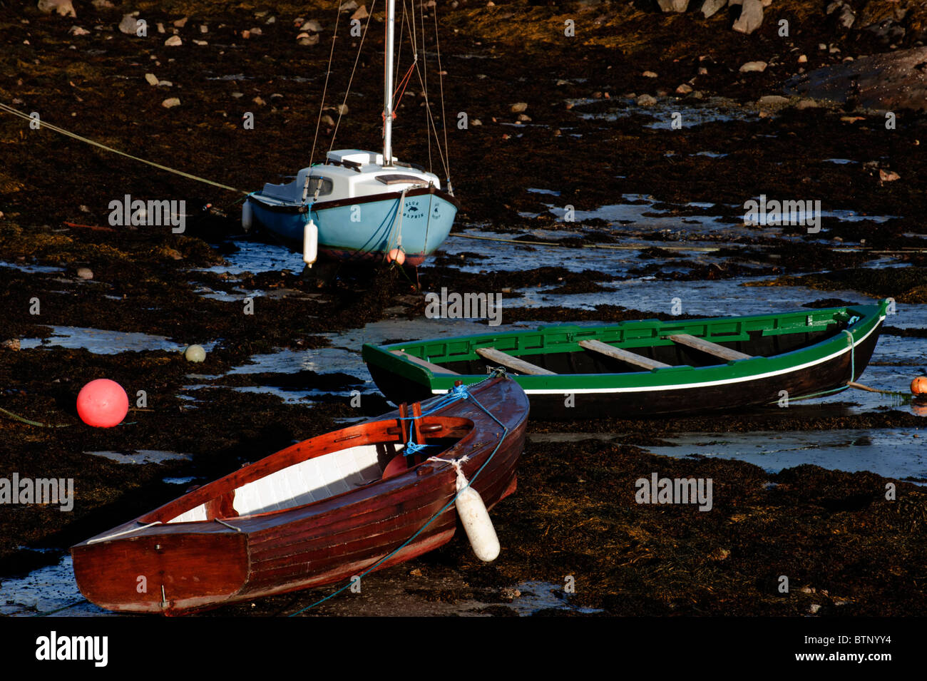 Boats in Spiddal harbour at low tide Stock Photo - Alamy