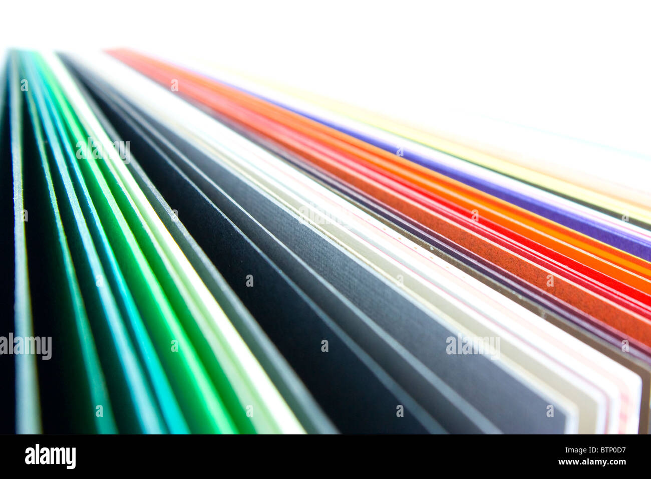 coloured papers bound in a book on white background Stock Photo - Alamy