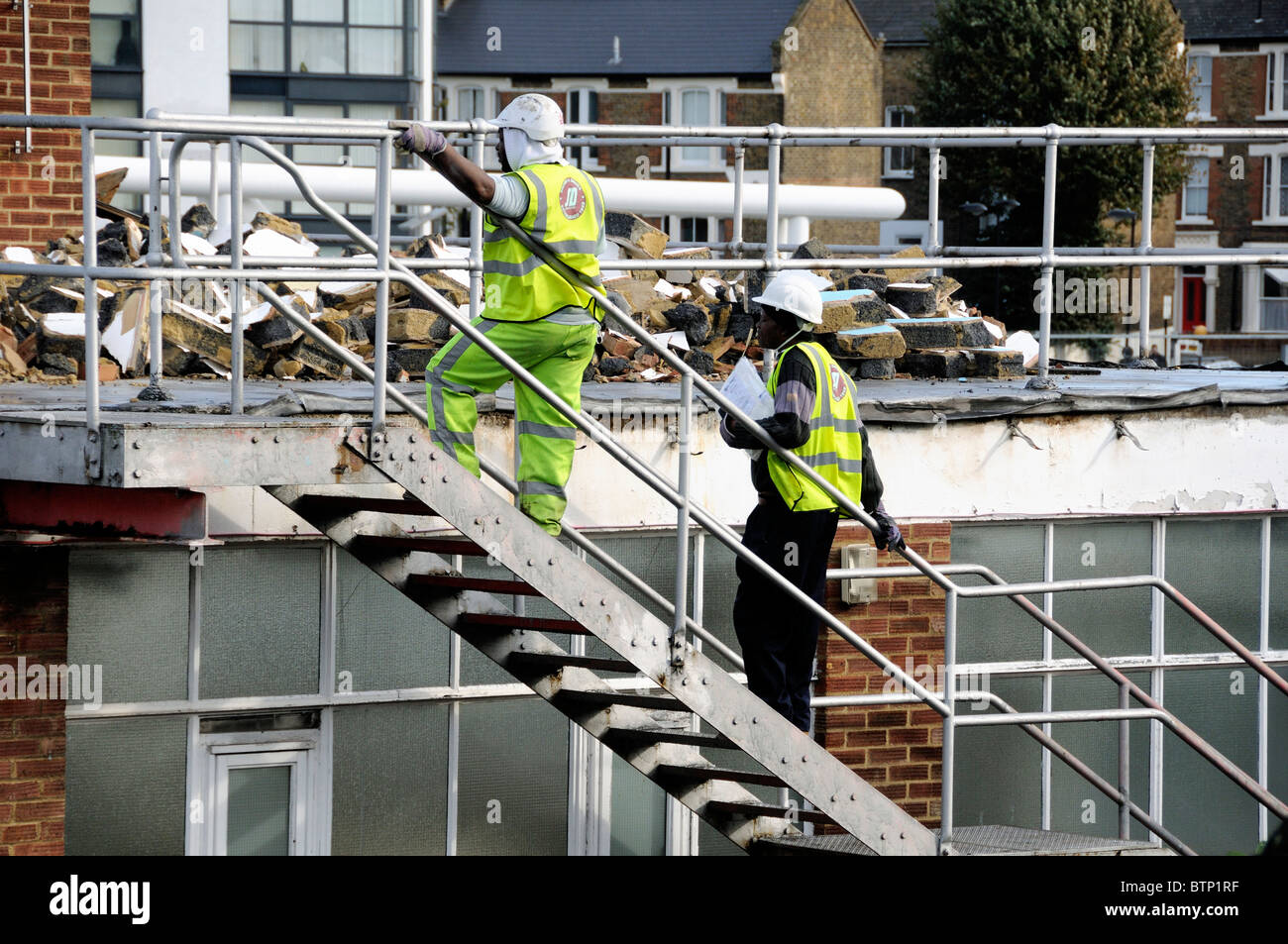 Construction workers standing on a stairway Stock Photo - Alamy