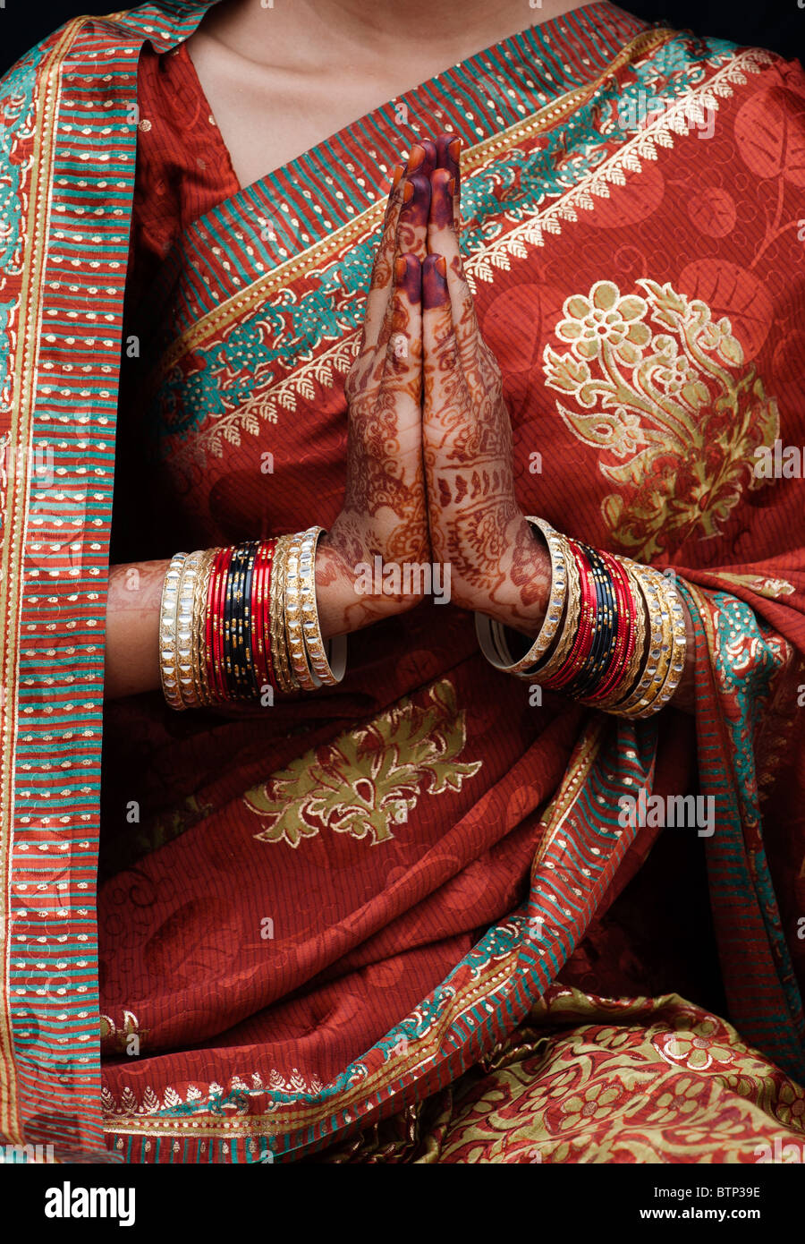 Indian girl wearing traditional silk sari with henna prayer hands ...