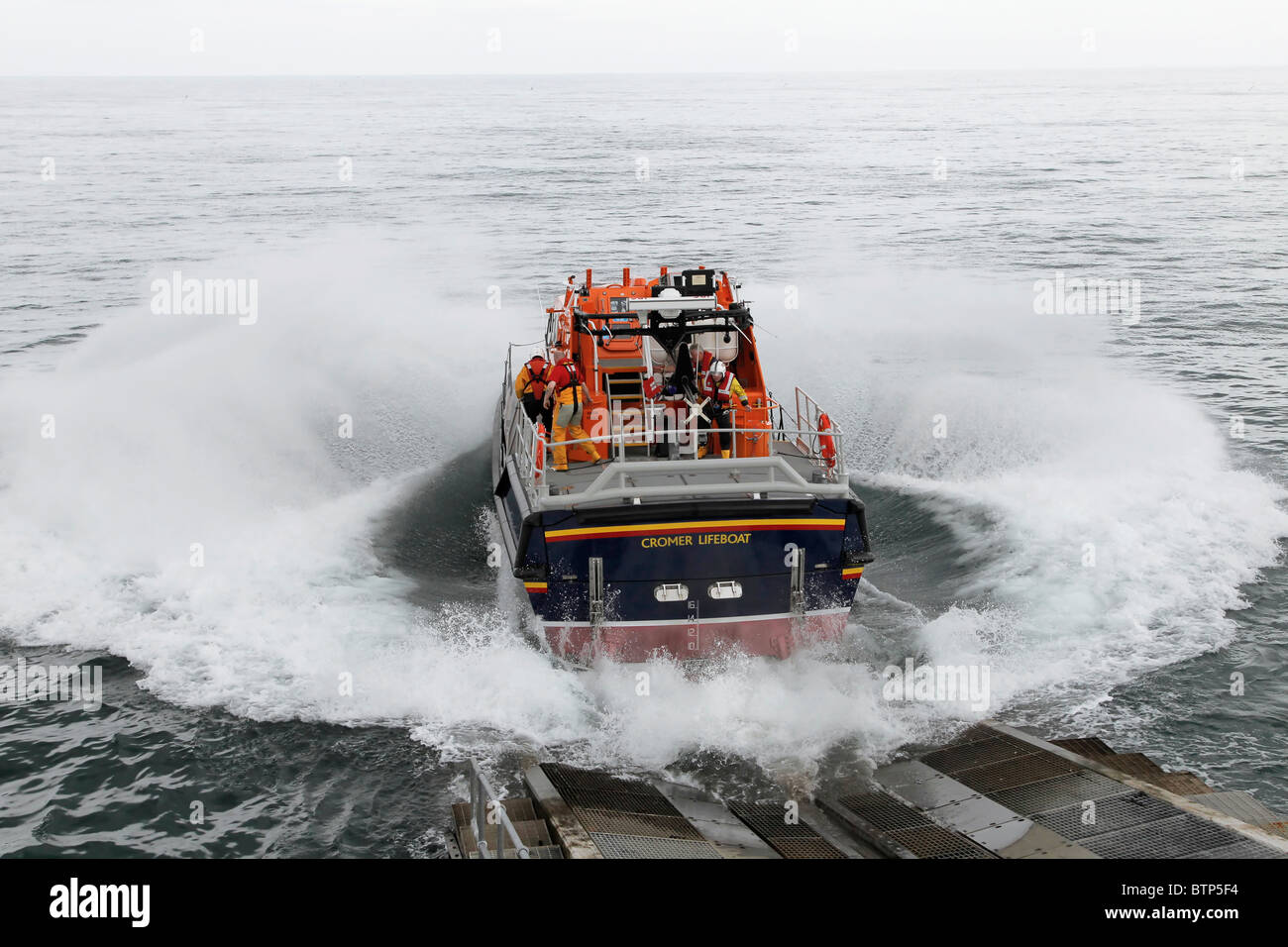 Cromer's RNLI Tamar class lifeboat launching down the ramp Stock Photo ...