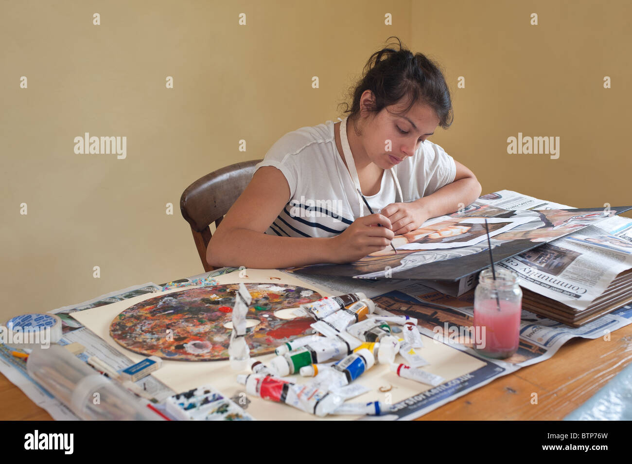 Teenager engaged with detailed art work Stock Photo - Alamy