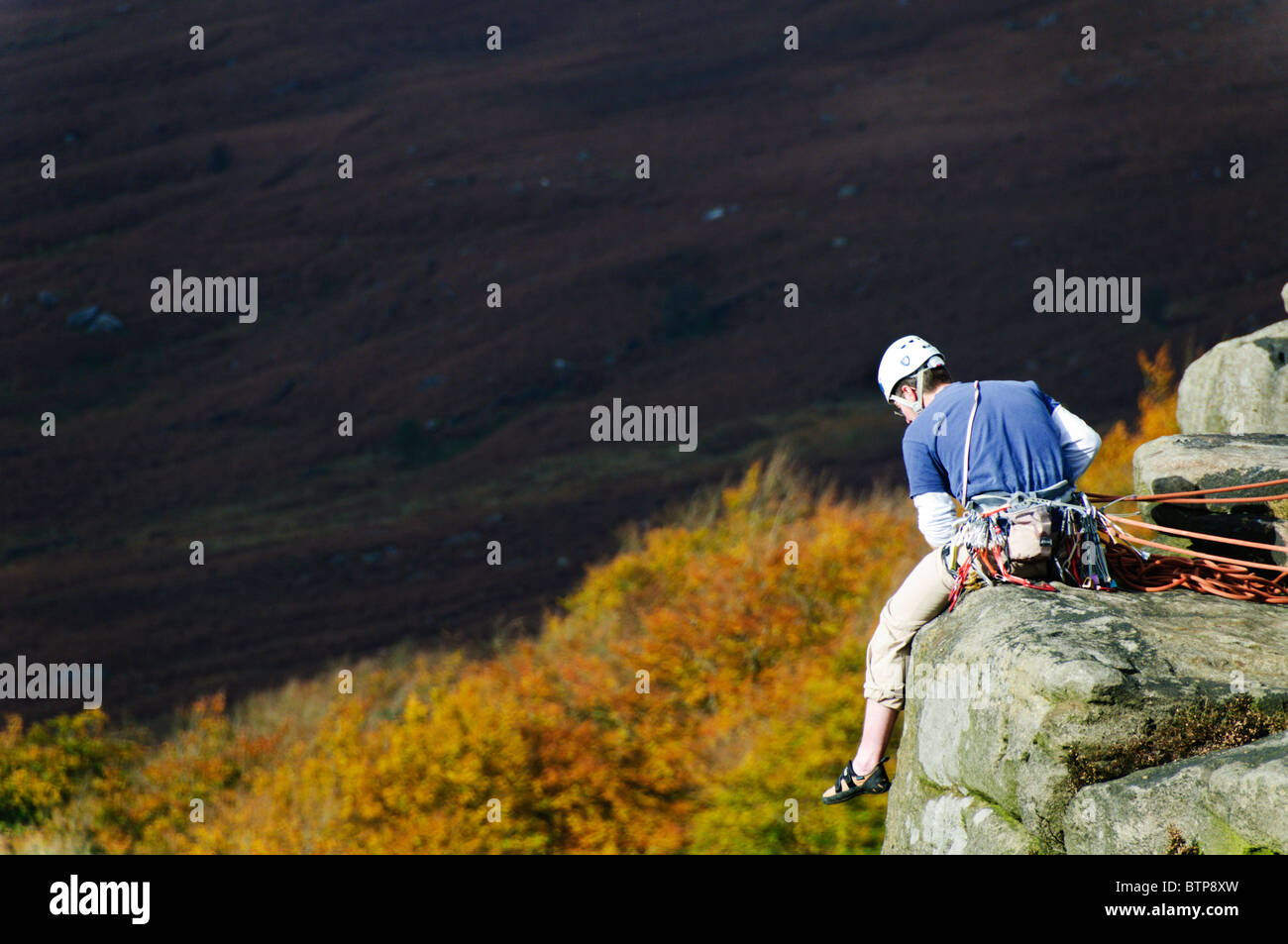 Rock climbing on Stanage Edge in the Peak District, Derbyshire, England ...