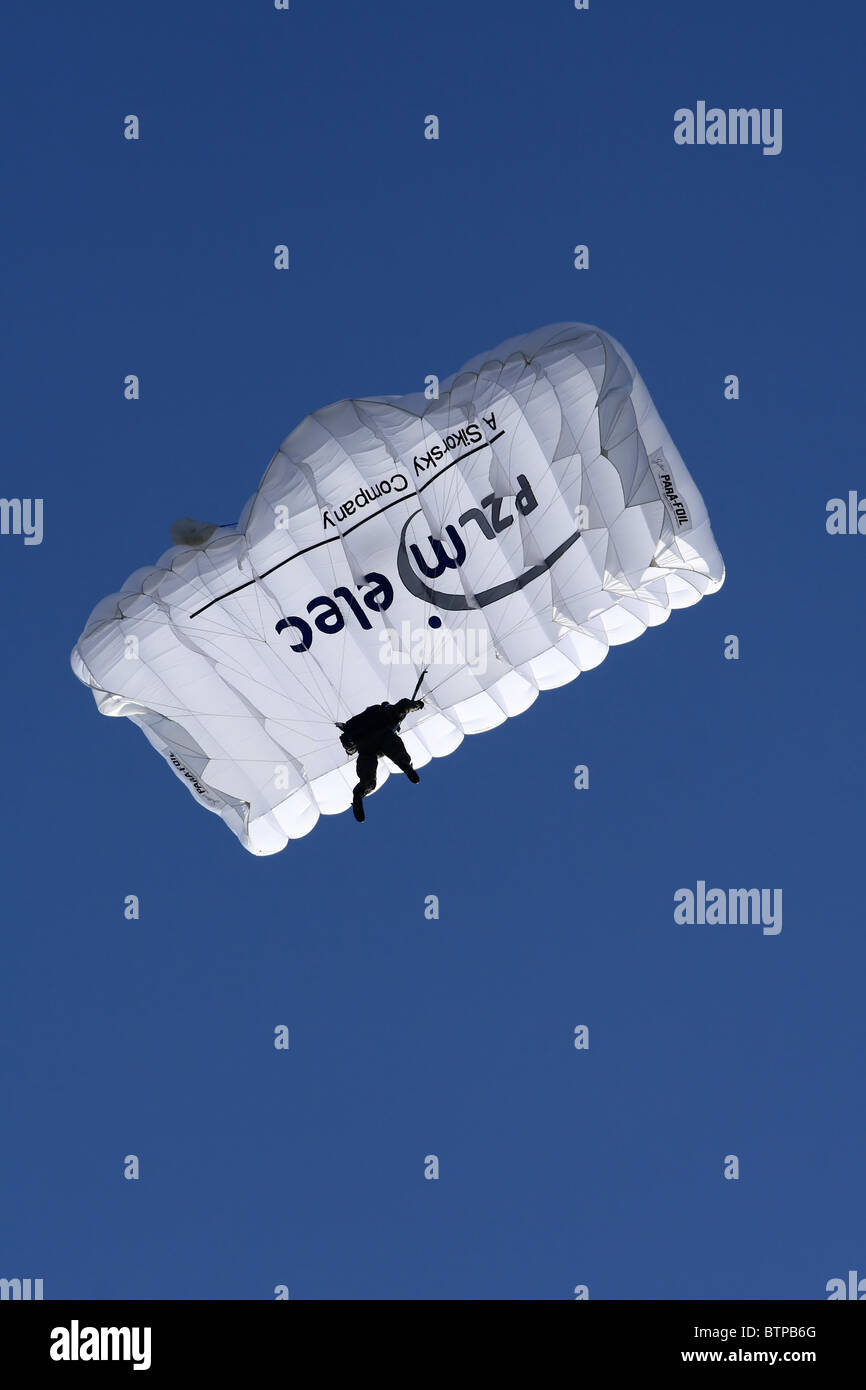 Parachute on a bright blue sky. Training of paragliders. Sport airfield ...