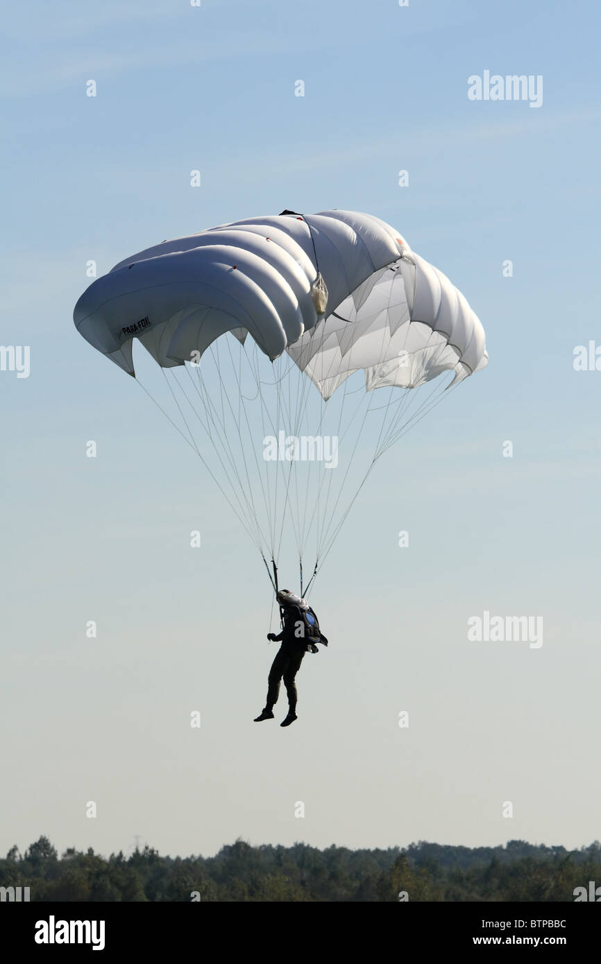 Parachute on a bright blue sky. Training of paragliders. Sport airfield ...